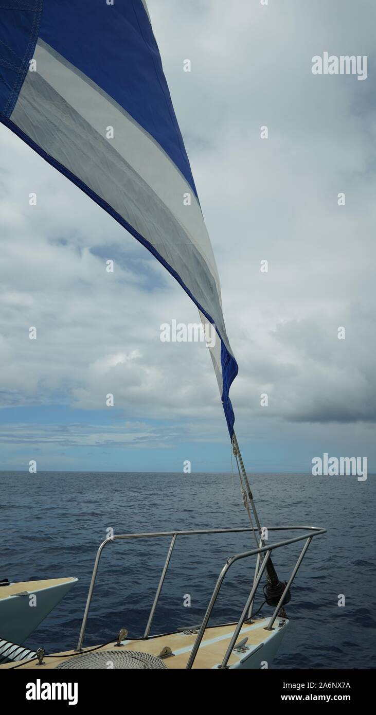 sailboat detail of bow and mast sailing on the ocean towards the ...