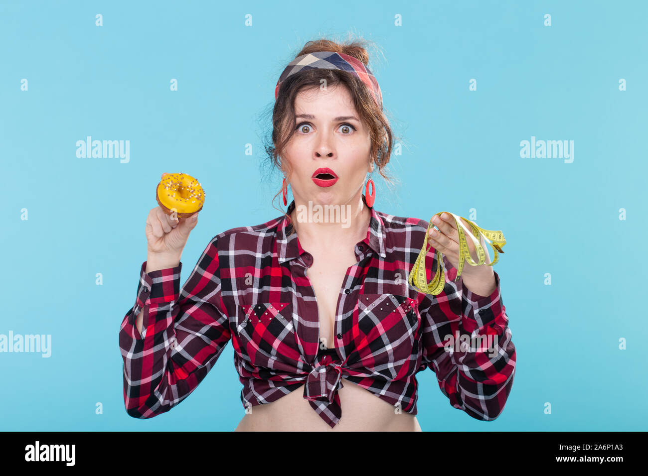 Diet, weight loss and junk food - pin-up woman choosing between dessert ...