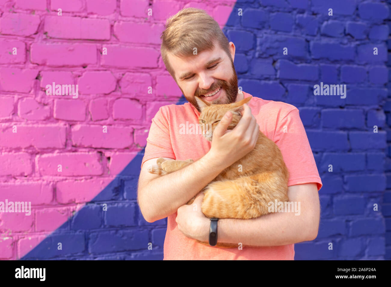 Pet owner and friendship concept - Handsome man is holding and hugging ...