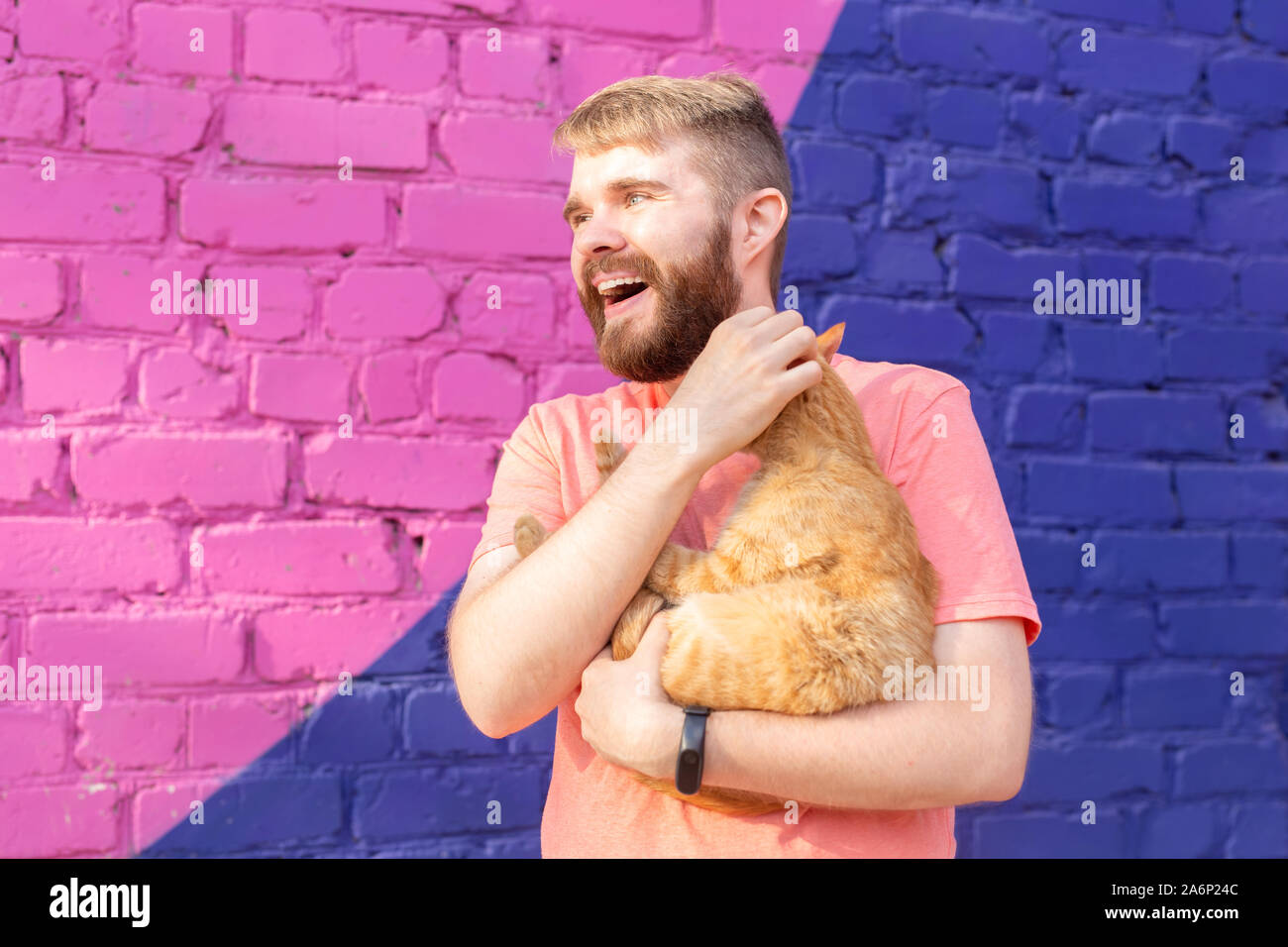 Pet owner and friendship concept - Handsome man is holding and hugging ...