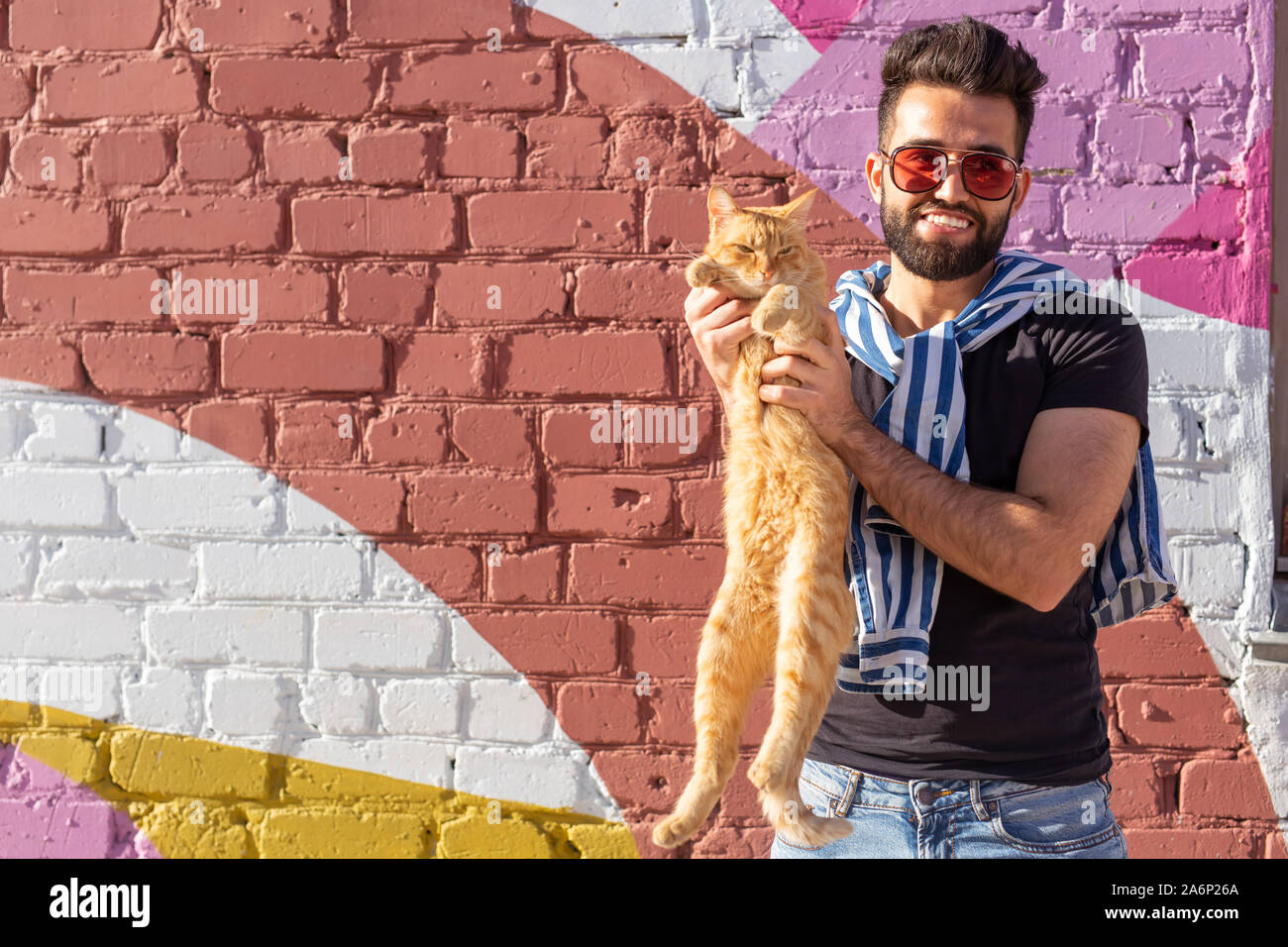 Pet owner and friendship concept - Handsome man is holding and hugging ...