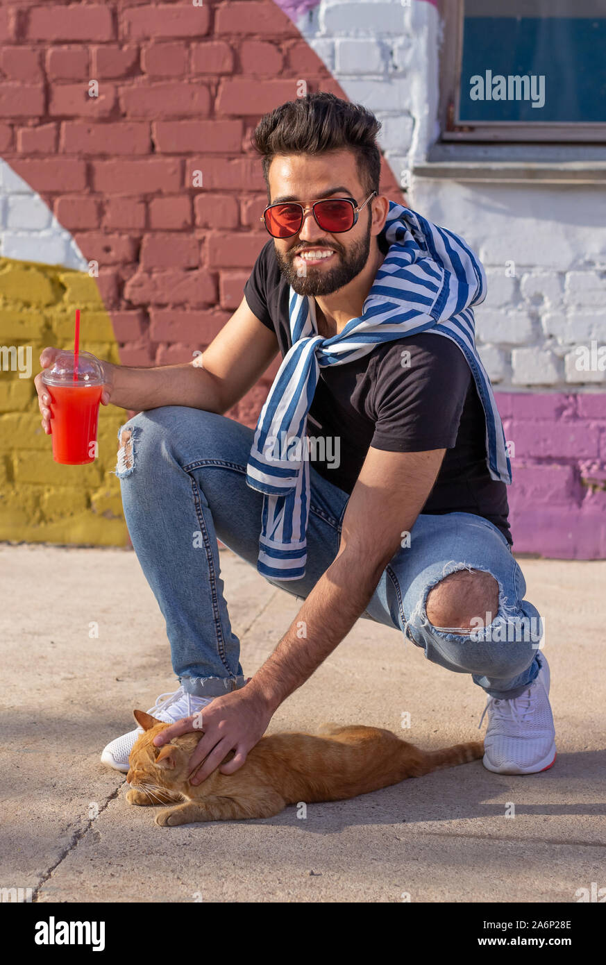 Pet owner and friendship concept - Handsome man is holding and hugging ...