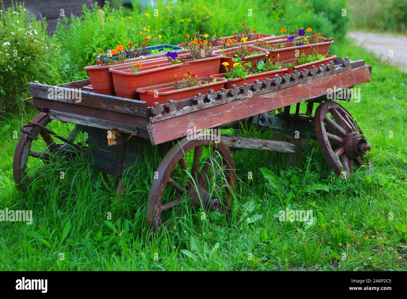 Decorative wooden cart with flowers Stock Photo - Alamy