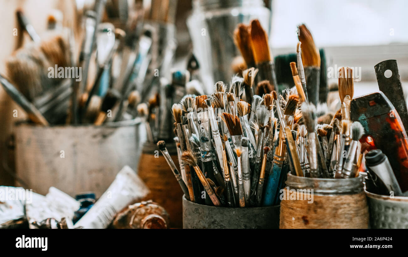 Table with brushes and tools in an art workshop. Background Stock Photo ...