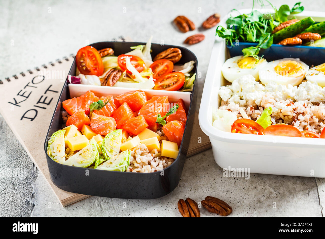 Lunch boxes with keto diet food, top view. Rice with fish, cheese, eggs ...