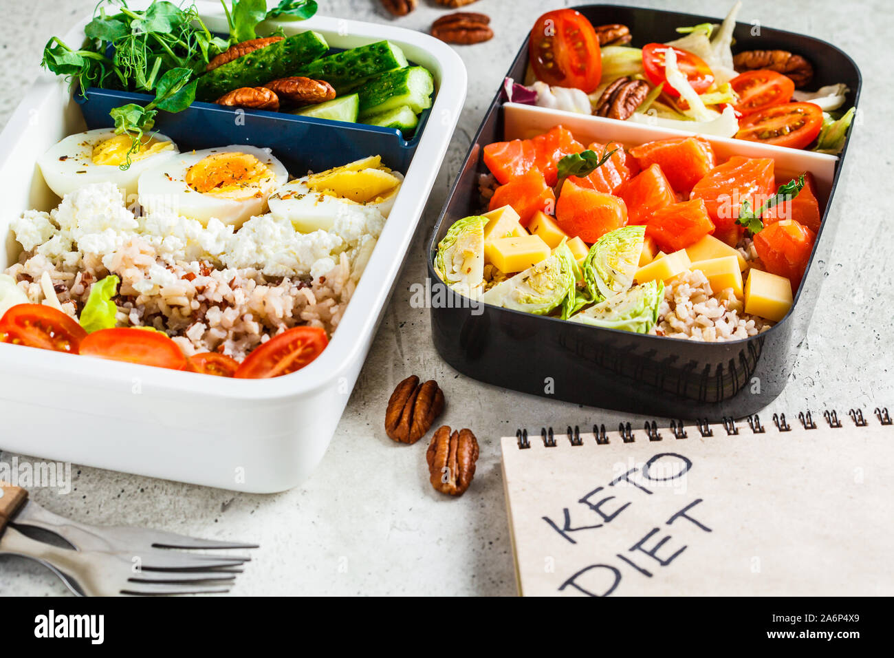 Lunch boxes with keto diet food, top view. Rice with fish, cheese, eggs ...