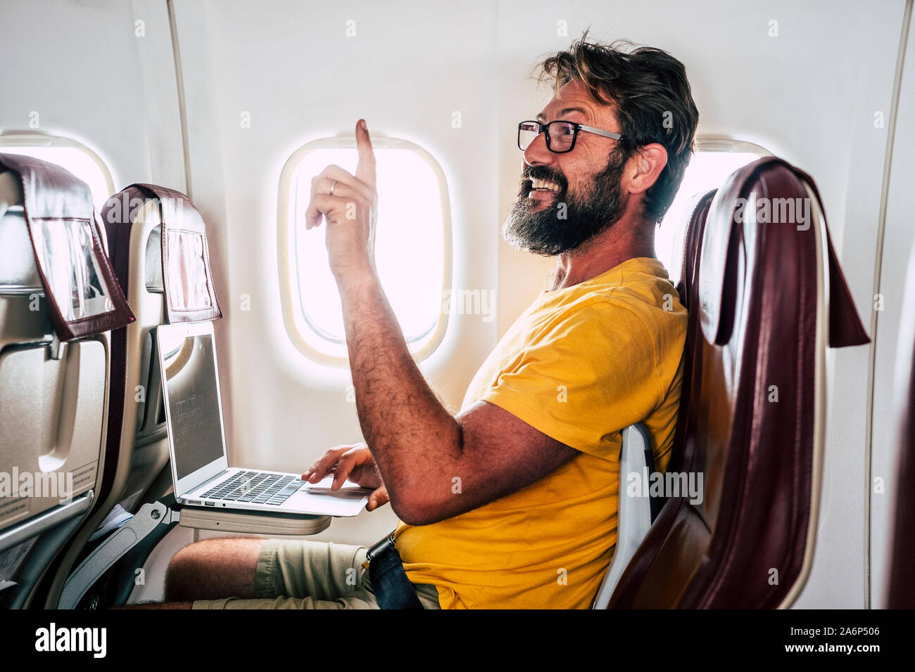 Bearded caucasian adult man sit down inside the airplane flight asking ...