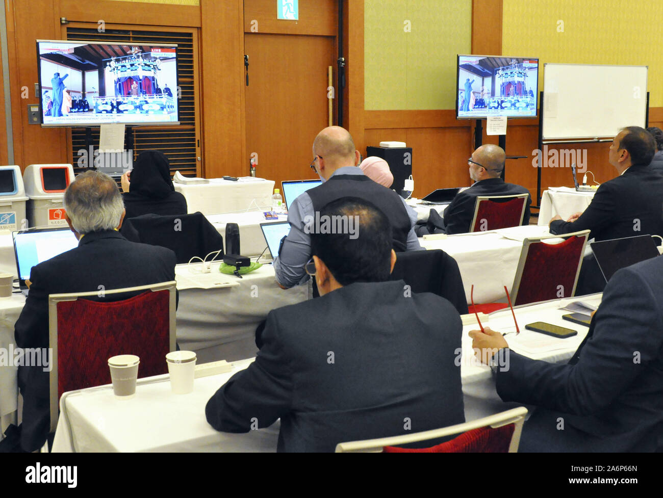 Reporters from foreign media on Oct. 22, 2019, watch screens in Tokyo ...