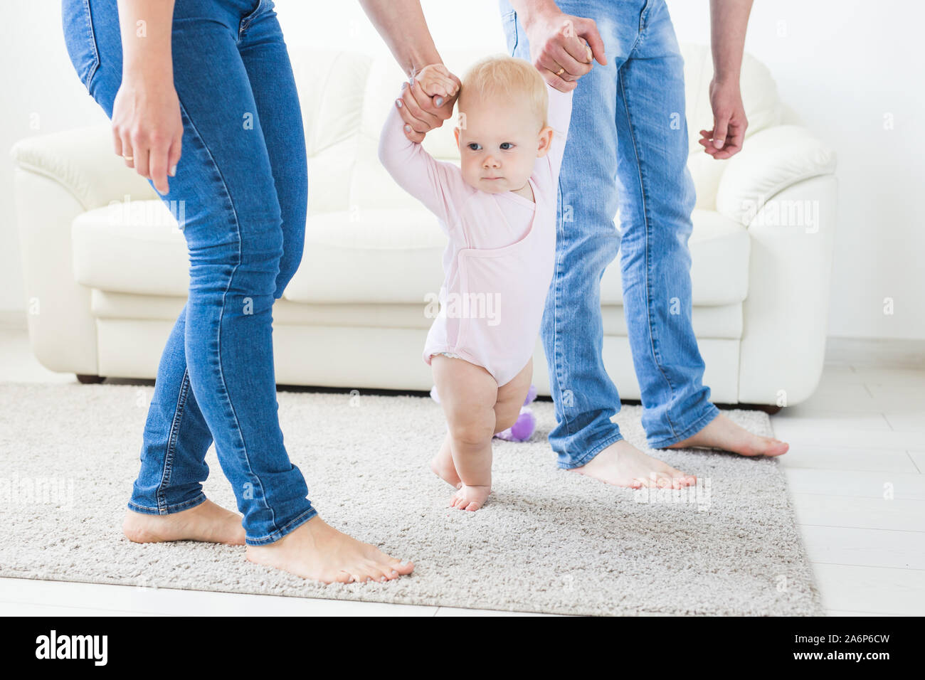 First steps. Little baby girl learning to walk Stock Photo - Alamy