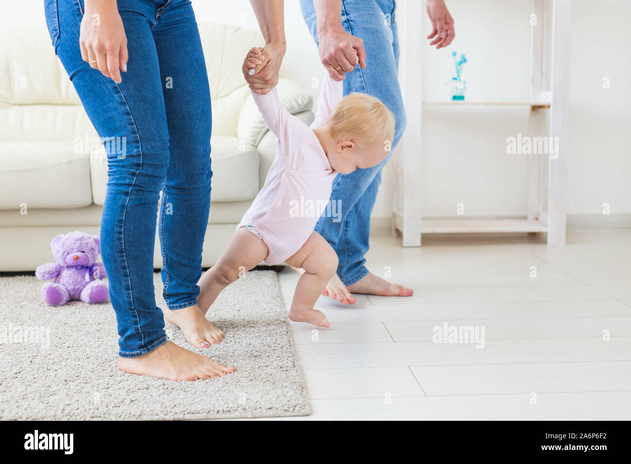 First steps. Little baby girl learning to walk Stock Photo - Alamy