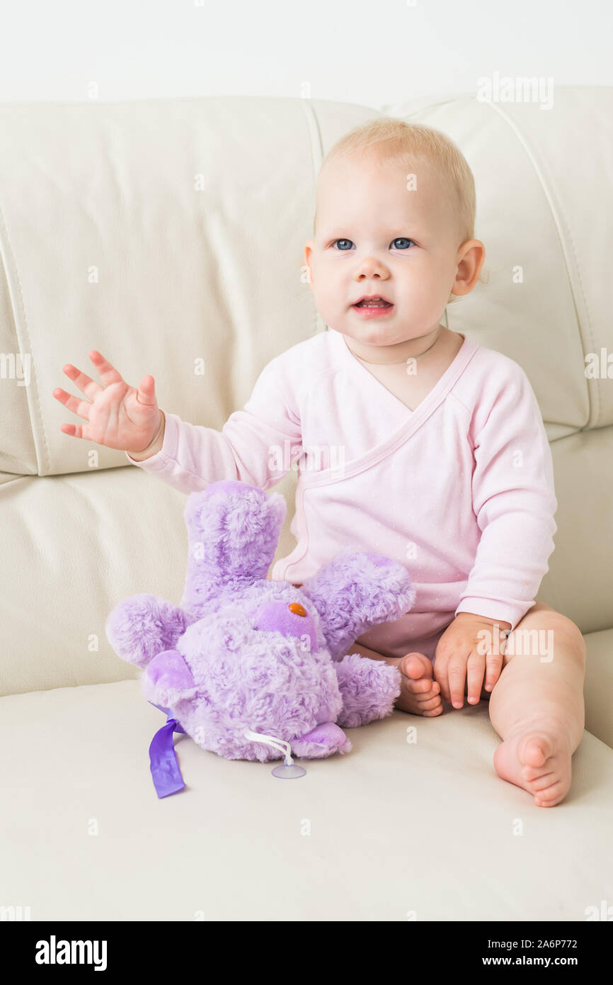 childhood, babyhood and people concept - happy little baby girl sitting ...