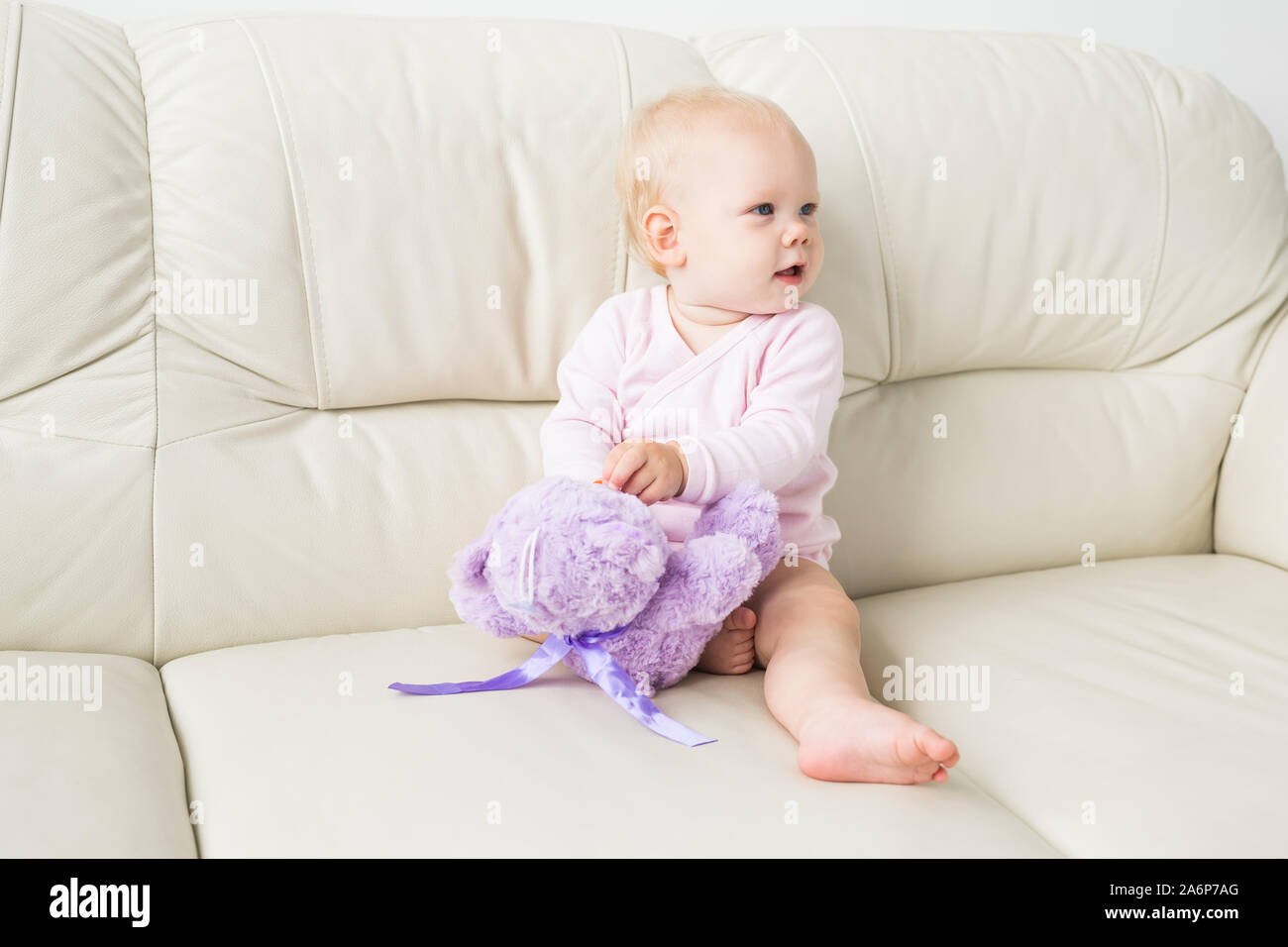 childhood, babyhood and people concept - happy little baby girl sitting ...