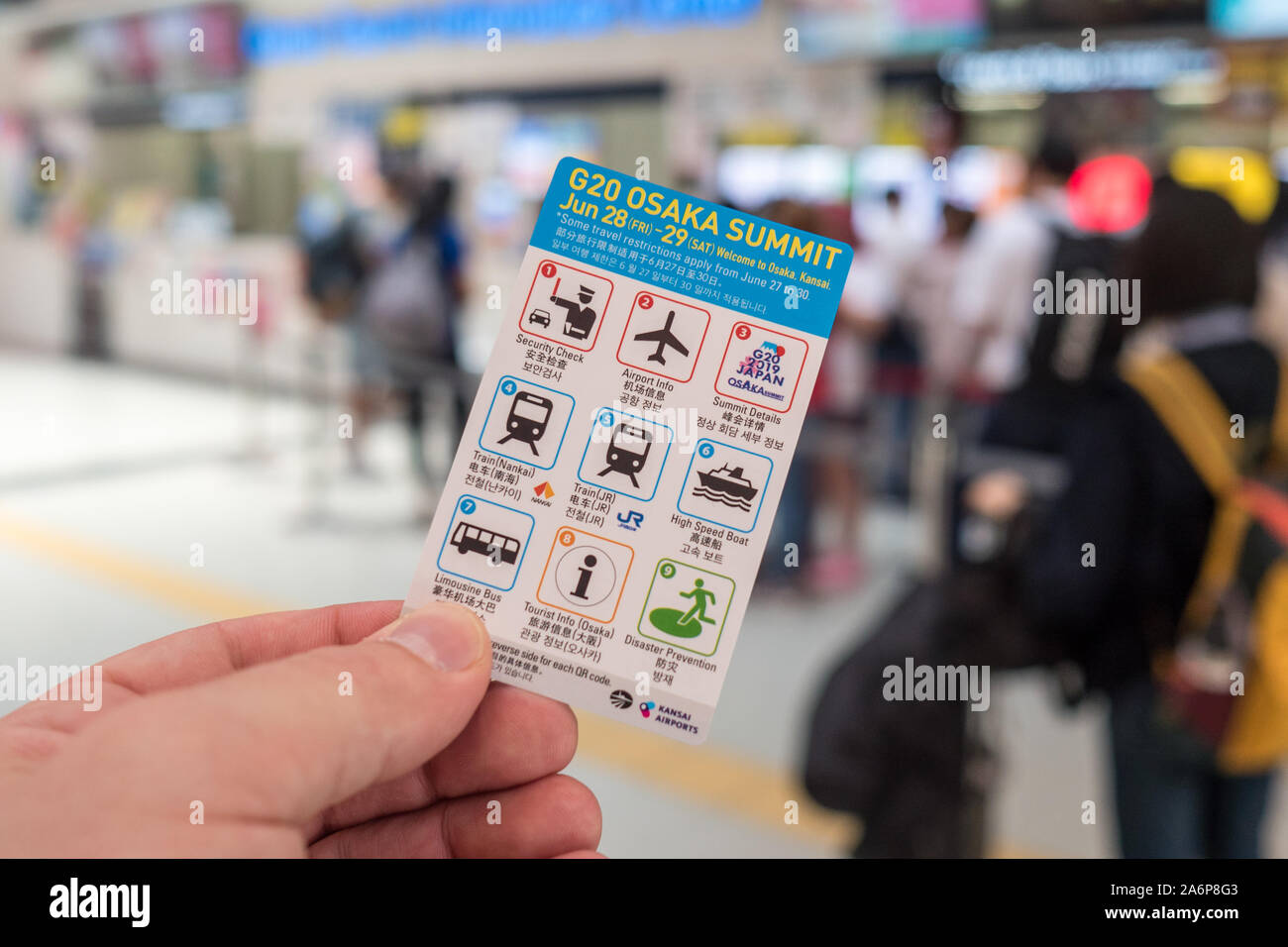G20 : man hand handling little card given to every arriving traveler ...