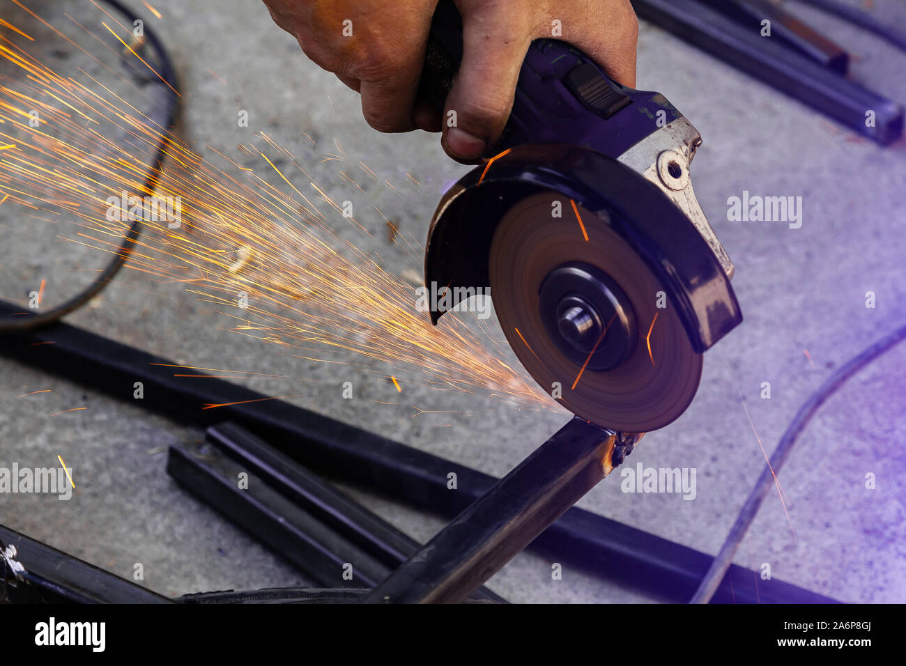 Close-up view strong man master without gloves on arms, performs metal ...