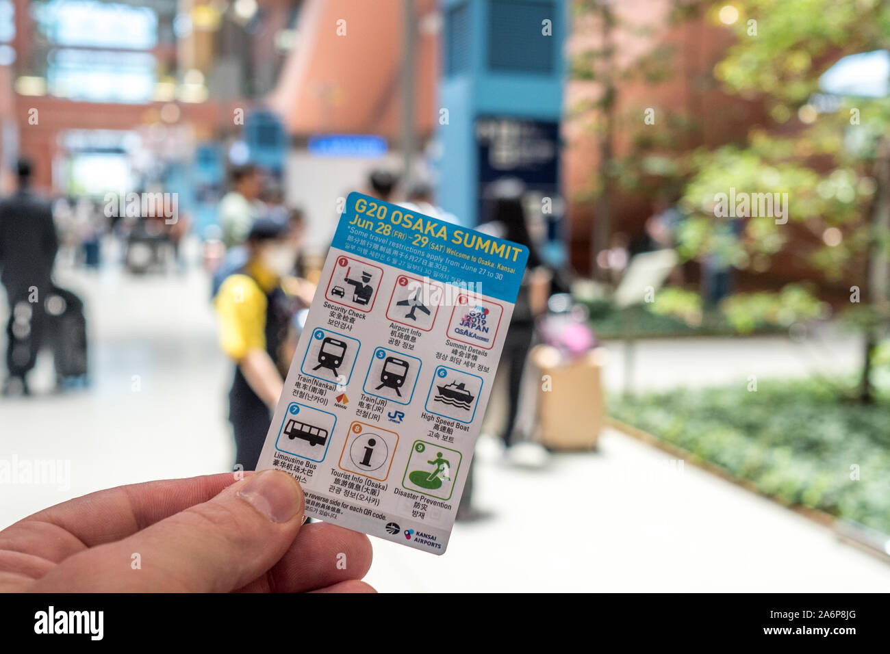 man hand handling G20 little card given to every arriving traveler from ...