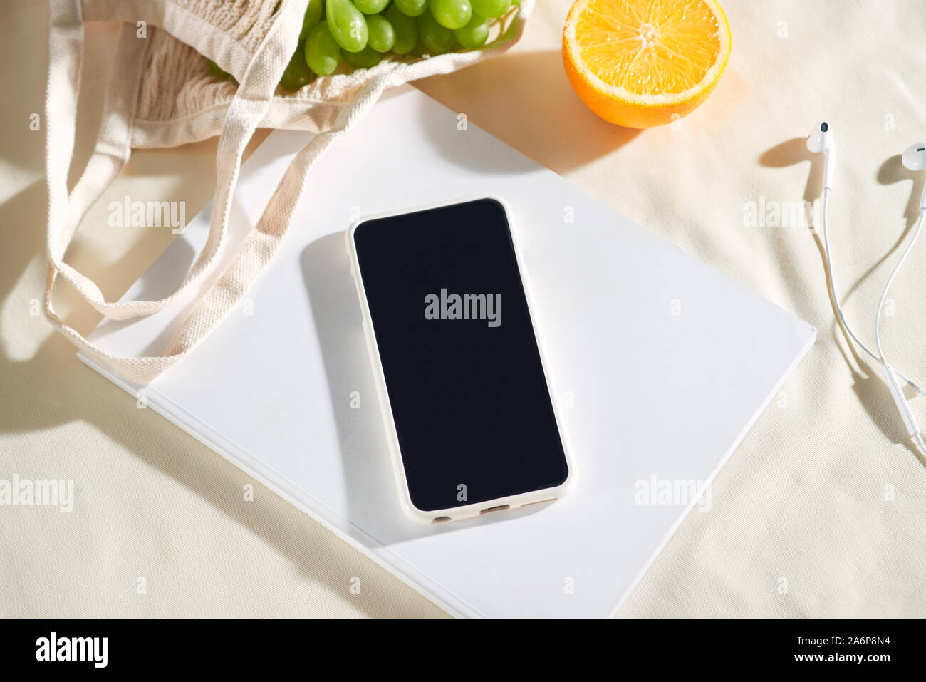 Summer holiday, gadget, fruit, camera, juice on light fabric background ...