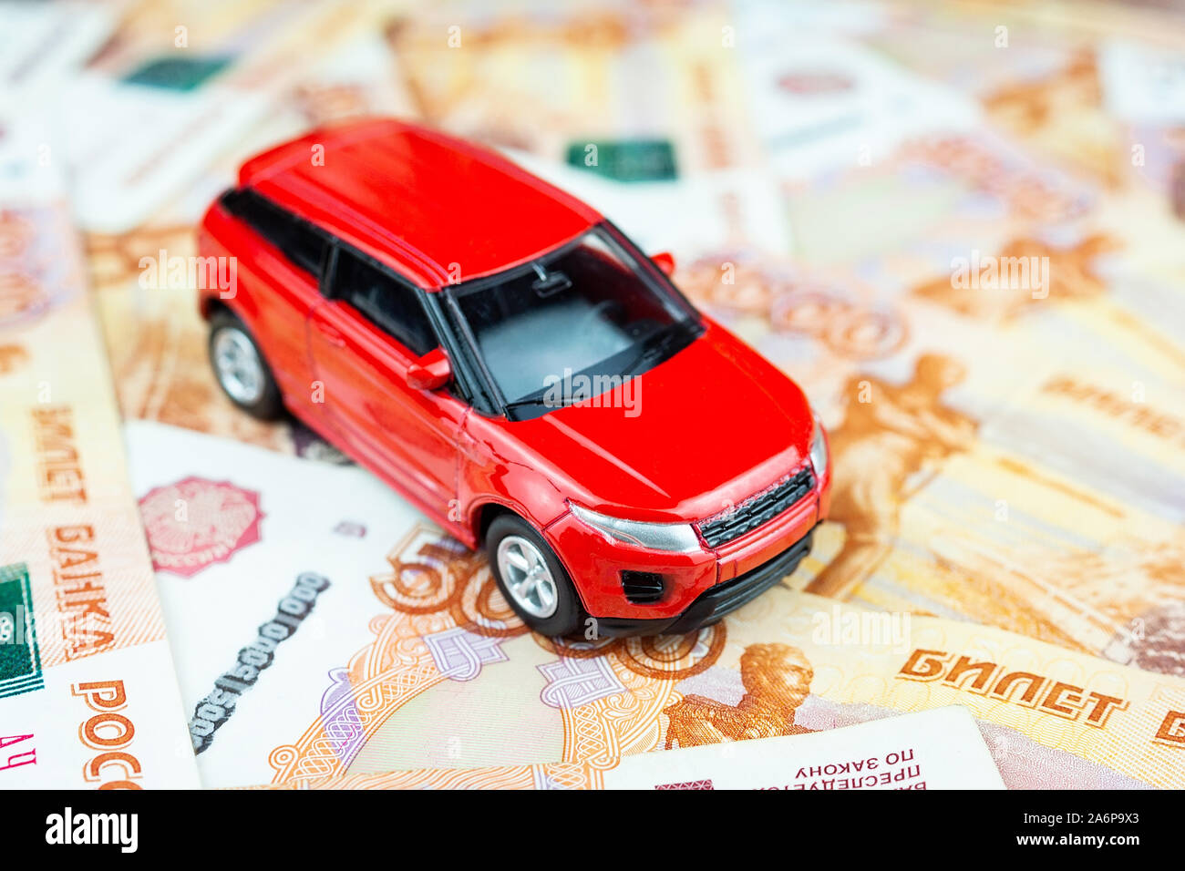 The red car is on the money, a Toy car on money Stock Photo - Alamy