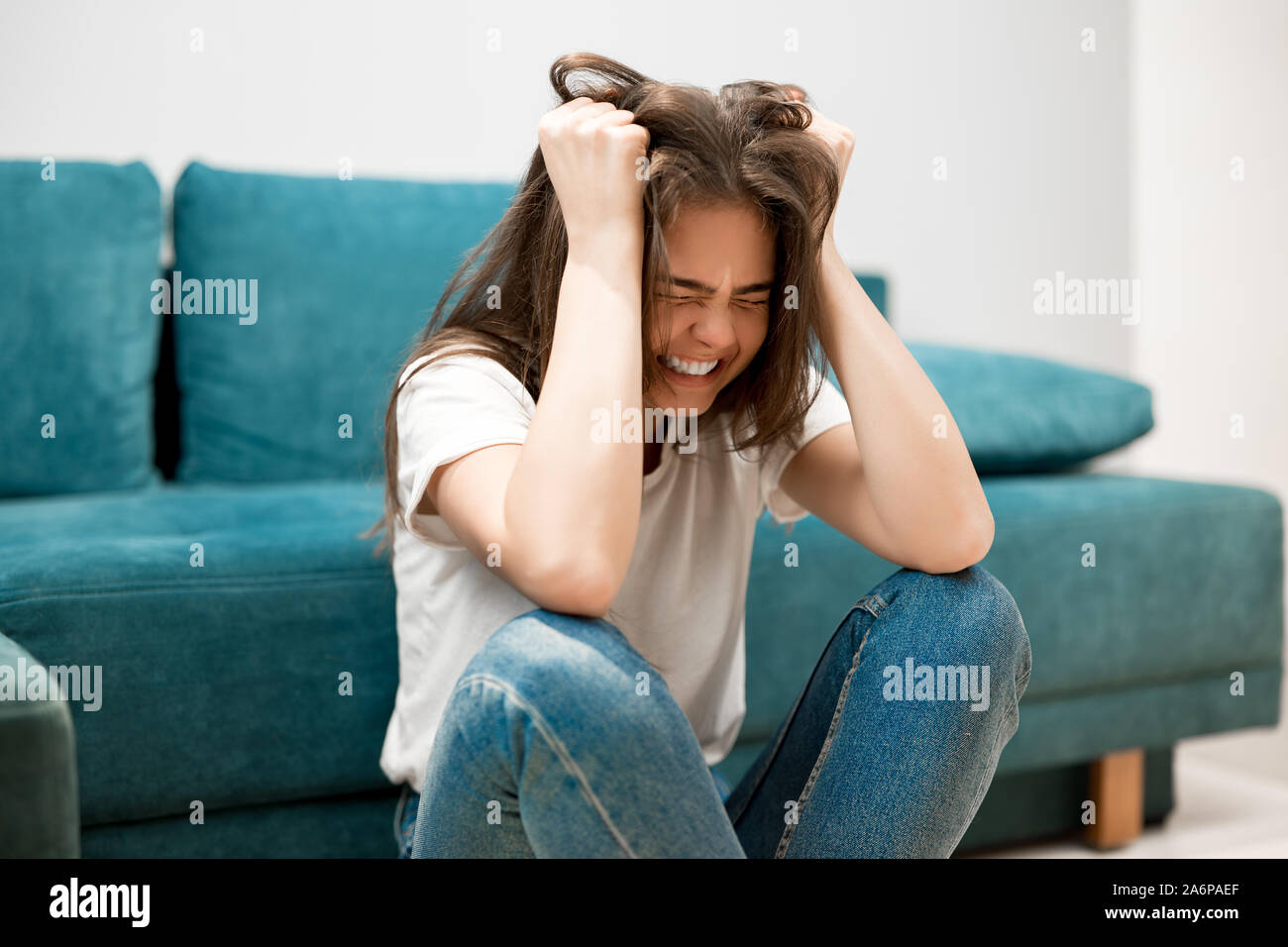 beautiful young woman crying feeling very depressed sitting on floor ...