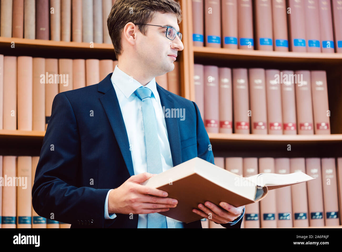Lawyer in his office reading precedents in thick books Stock Photo - Alamy