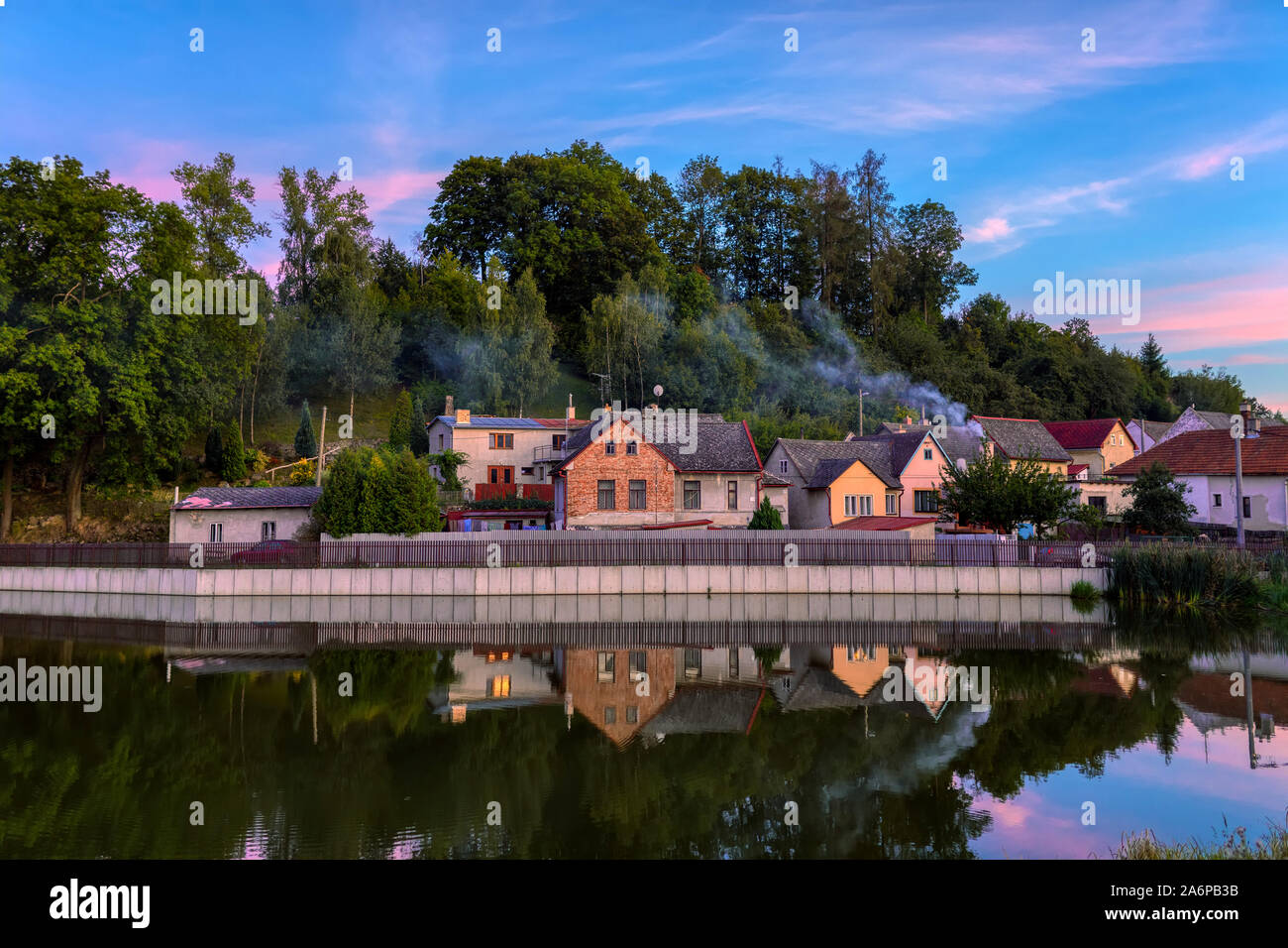 Small village houses reflection in pond water. Village house reflected ...