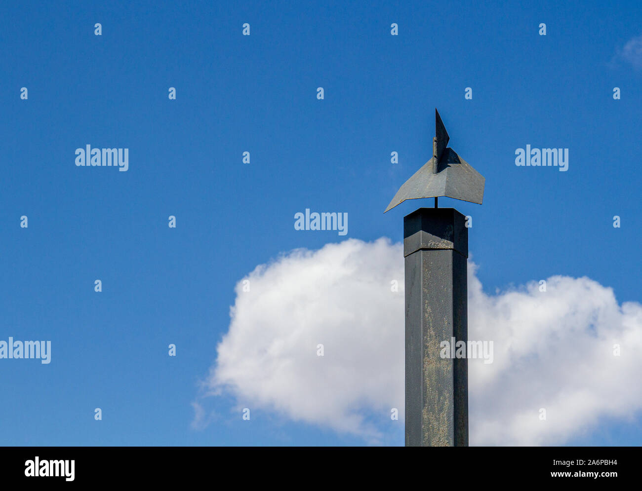 Black chimney and a white cloud isolated against a clear blue sky image ...