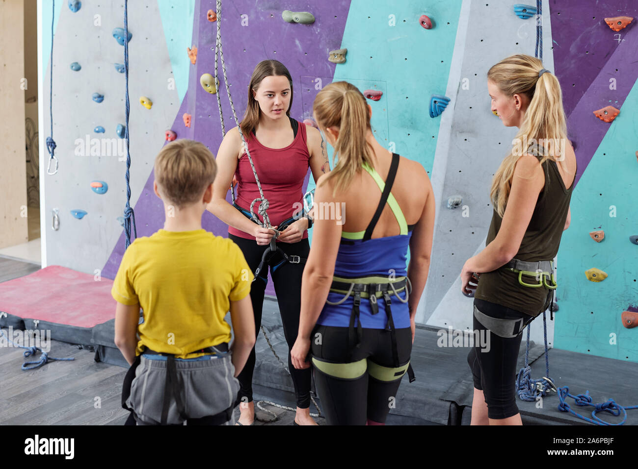 Young climbing instructor consulting group of active young people Stock ...