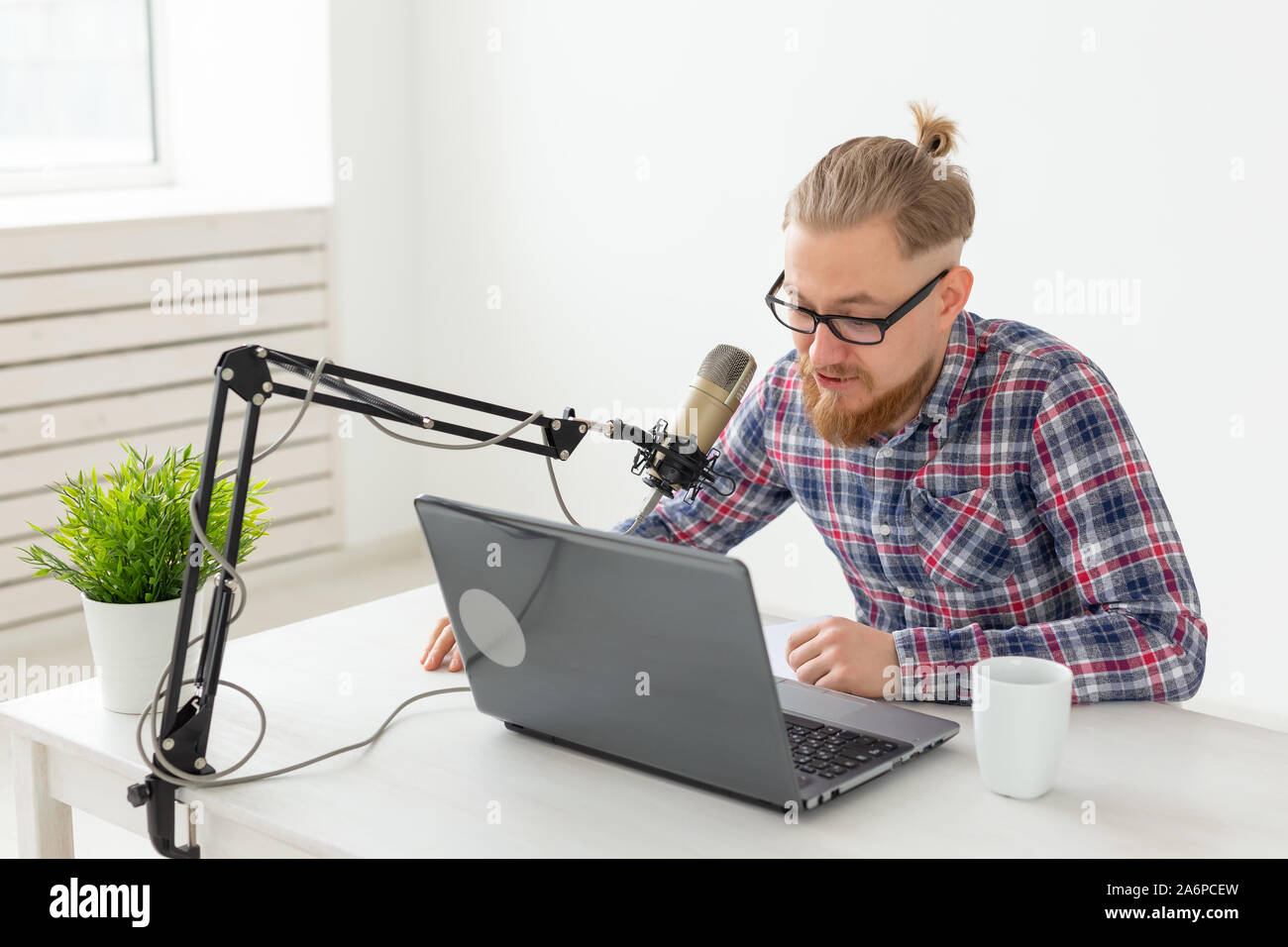 Radio, DJ, blogging and people concept - Smiling man sitting in front ...