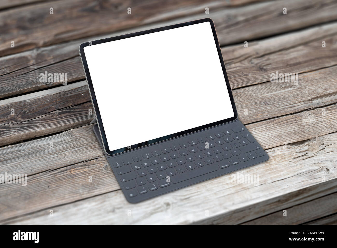 Tablet with keyboard on wooden table. Isolated screen for mockup Stock ...