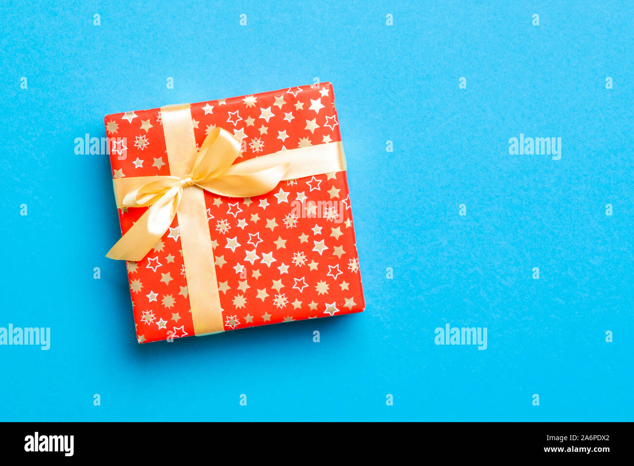 wrapped Christmas or other holiday handmade present in paper with gold ...