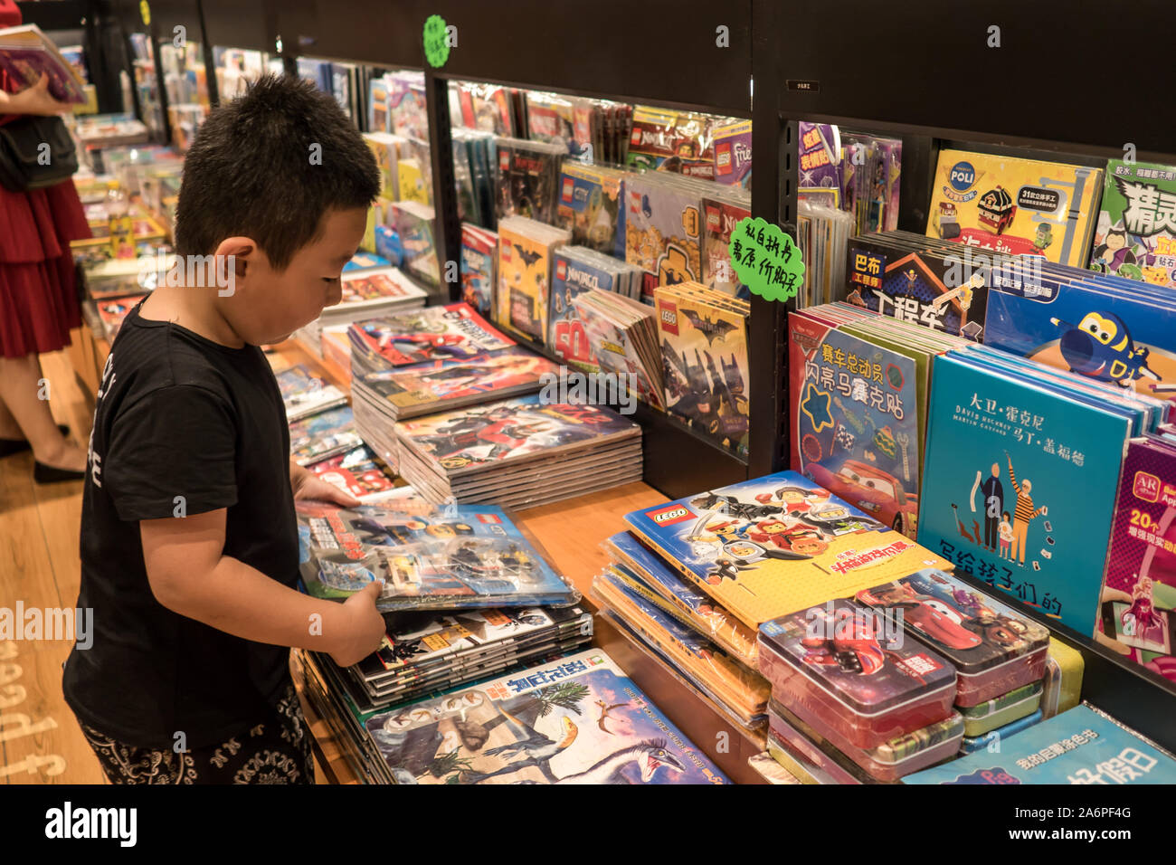 Little cute chinese boy looking at books for the youth in Dalian, China ...
