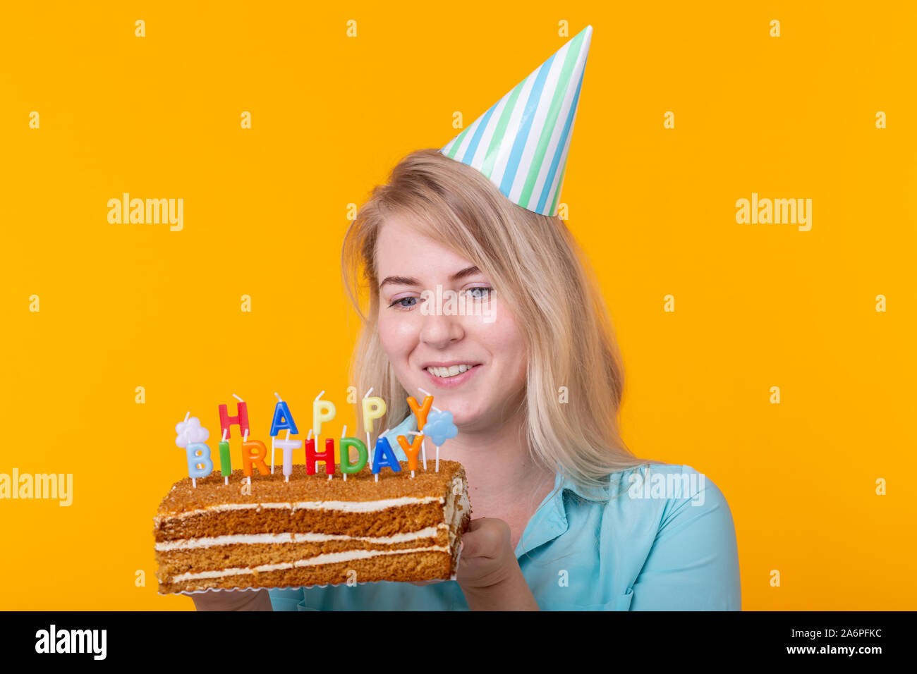 Holidays and party cocept - Positive young woman holding a happy ...