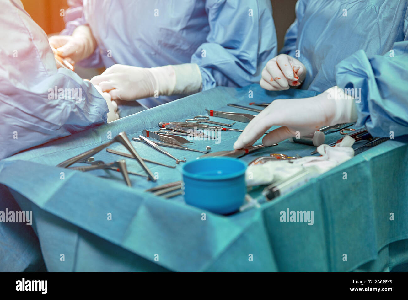 A sterile operating room table with instruments for surgery located on ...
