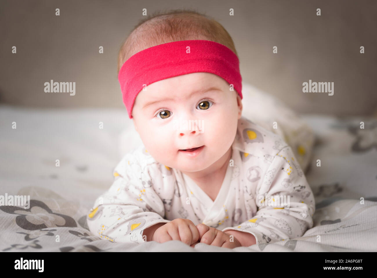 Baby girl lying on belly hi-res stock photography and images - Alamy