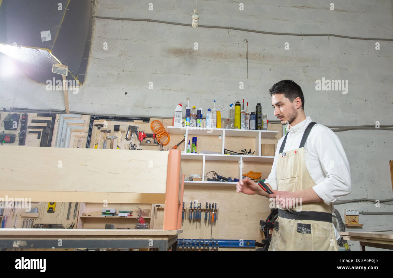 Small-Sized Companies, furniture and worker concept - Handsome young ...