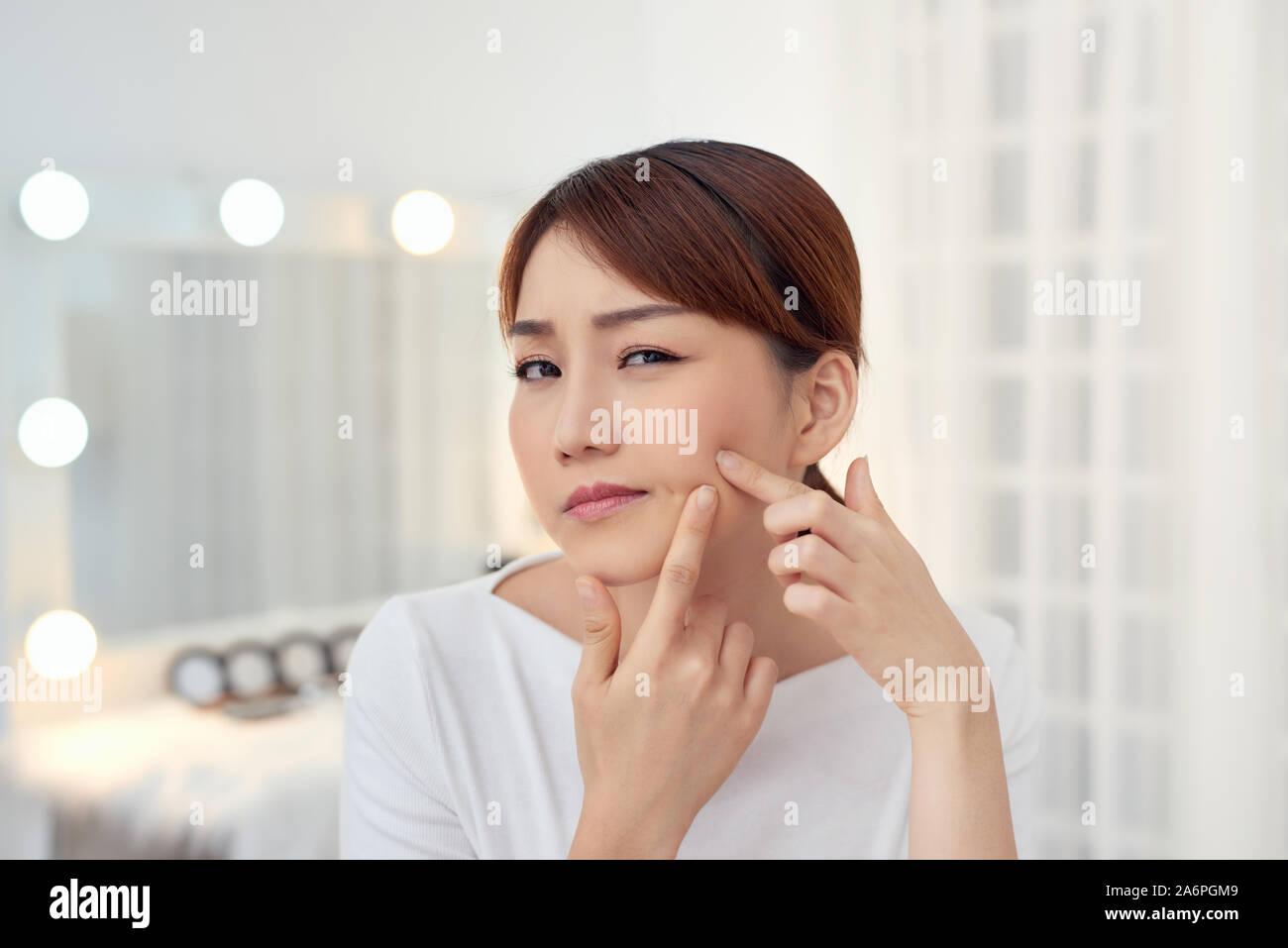 Young Asian woman unhappy touch her skin Stock Photo - Alamy