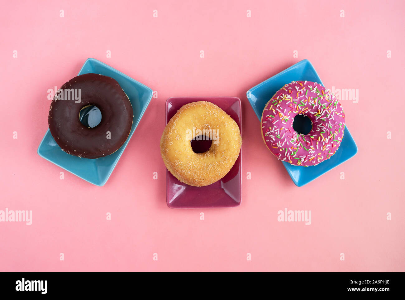 Glazed three donuts on a pink background with blank space Stock Photo ...