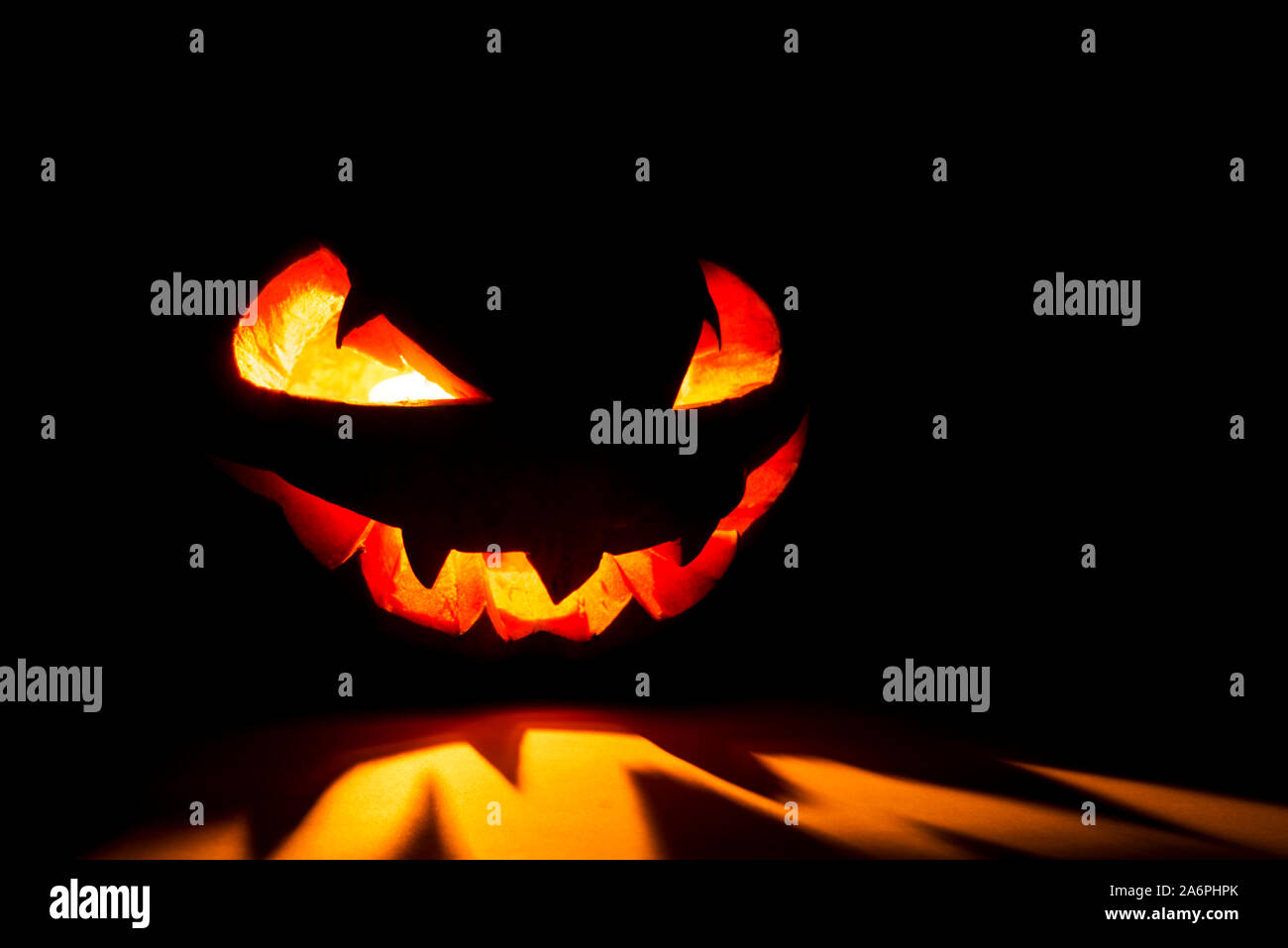 Halloween pumpkin smile and scary eyes for party night. Close up view ...