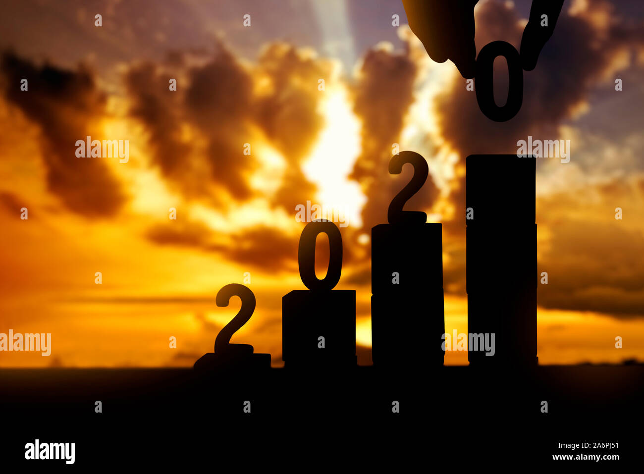 Silhouette of hand put the number 0 to make 2020 on stairs of a wooden ...