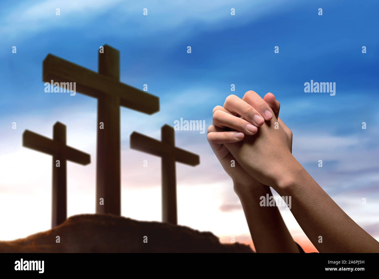 A human raised hands praying with to god with a blue sky background ...