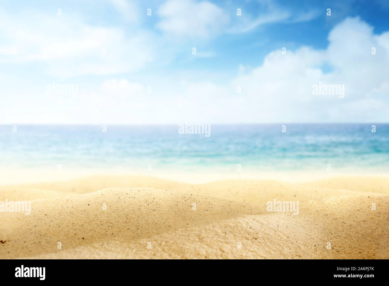 Sandy beach with the blue ocean and blue sky background Stock Photo - Alamy