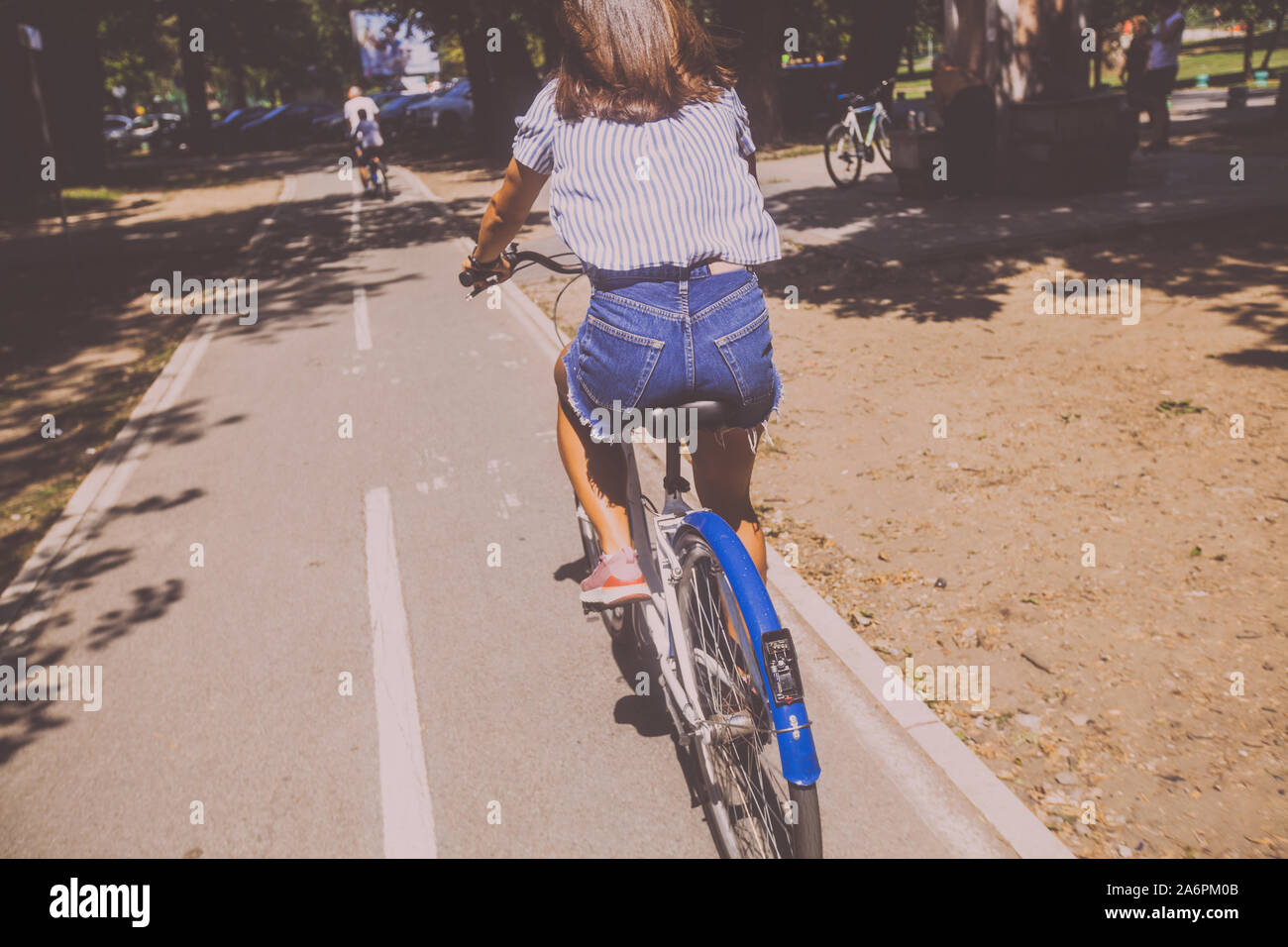 Back View Of Woman Riding Bicycle High Resolution Stock Photography and ...
