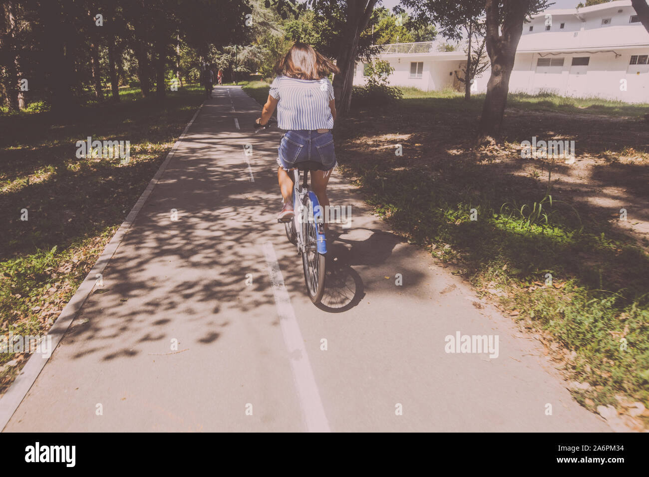 Back View Of Woman Riding Bicycle High Resolution Stock Photography and ...