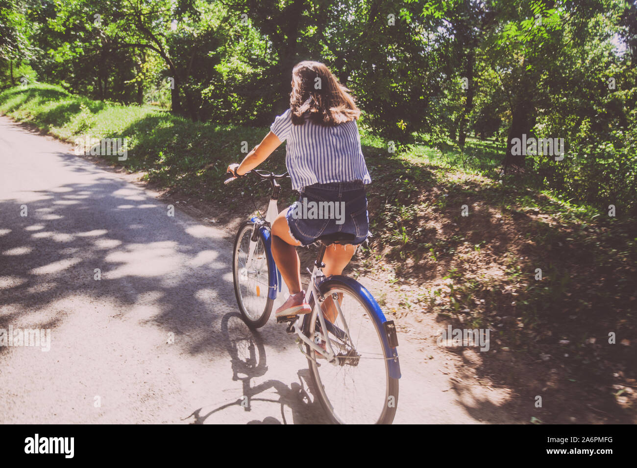 Back View Of Woman Riding Bicycle High Resolution Stock Photography and ...