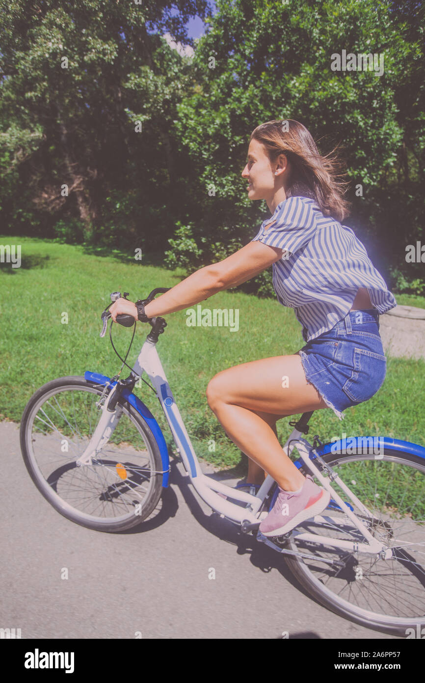 Back view girl riding bicycle hi-res stock photography and images - Alamy