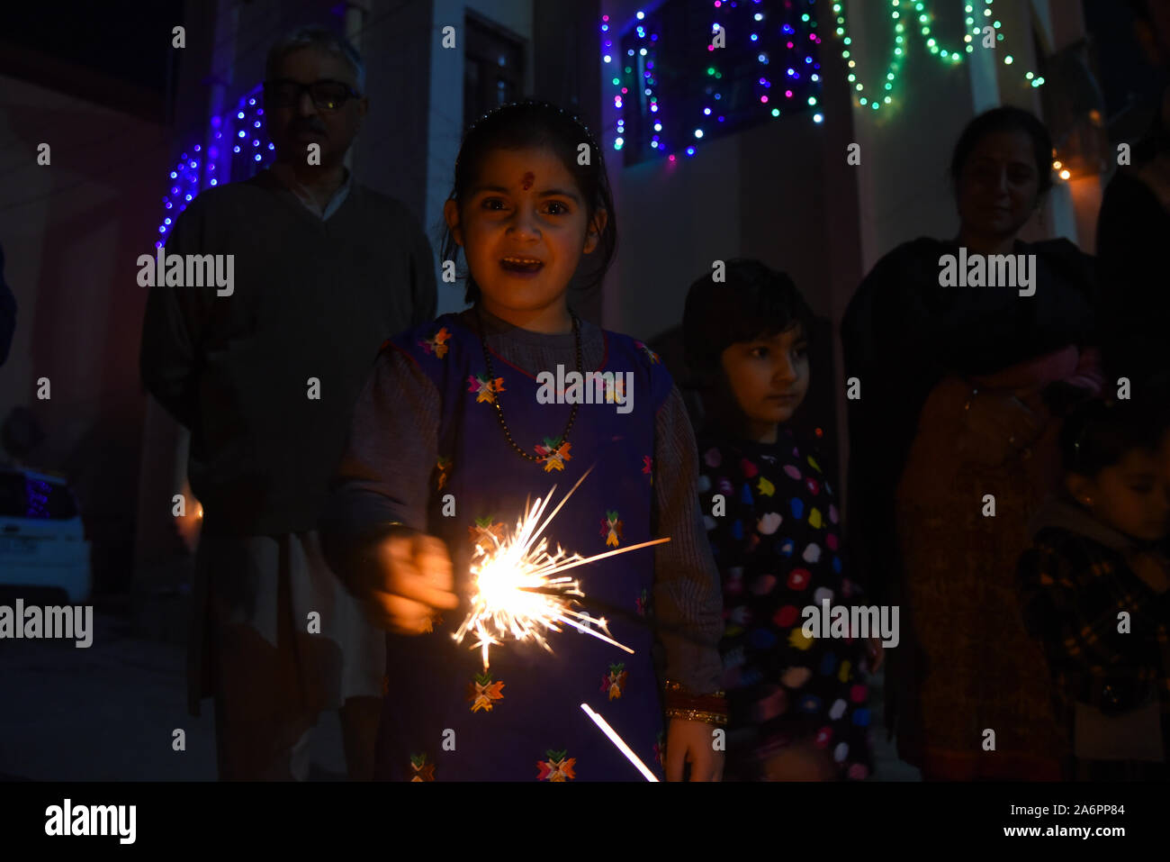 Srinagar, India. 28th Oct, 2019. A Kashmiri pandit girl lights a ...