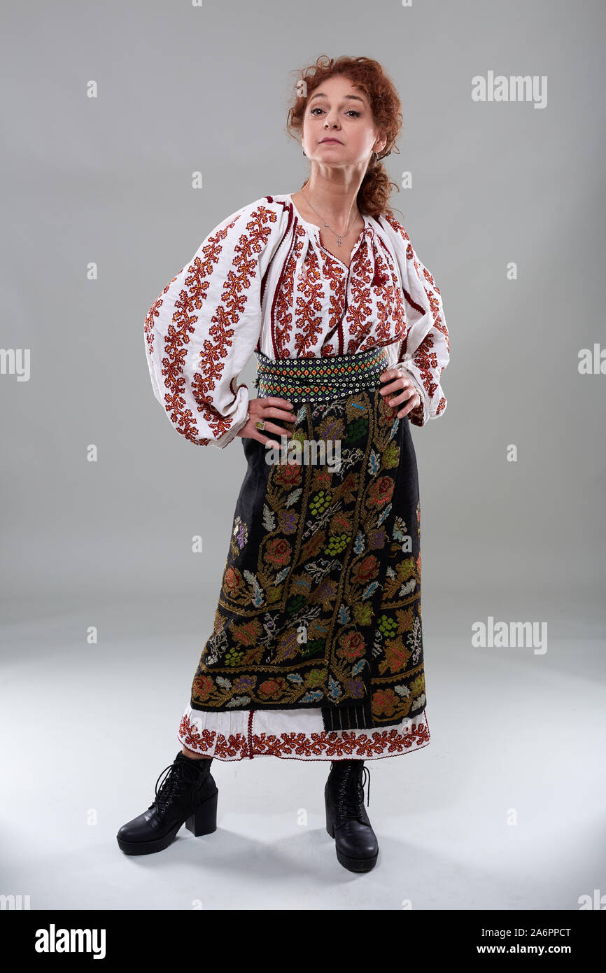 Mature Romanian woman in traditional costume on gray background Stock ...
