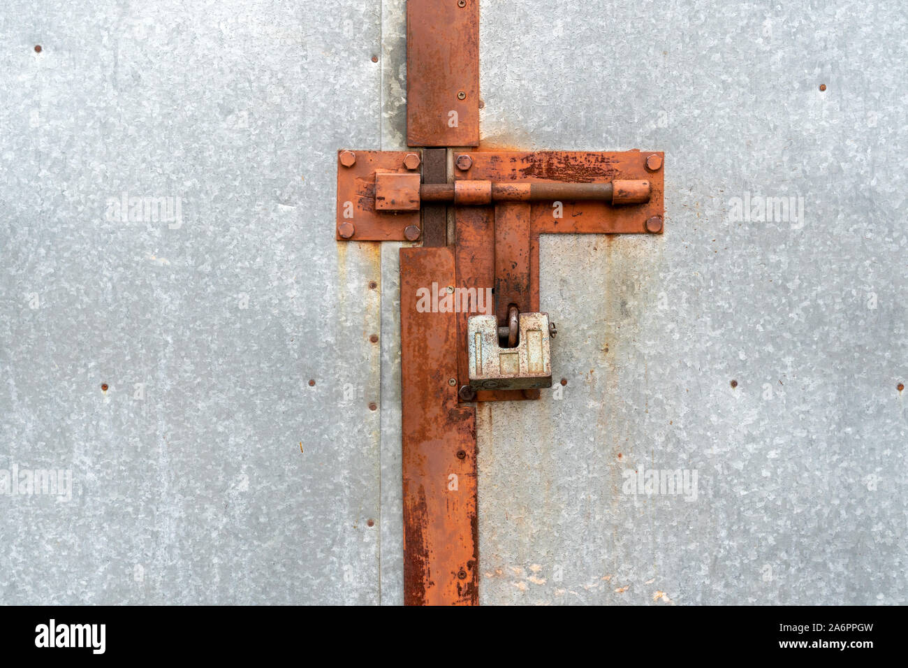 Rough metal gate on lock close-up. Grunge background of metallic door ...