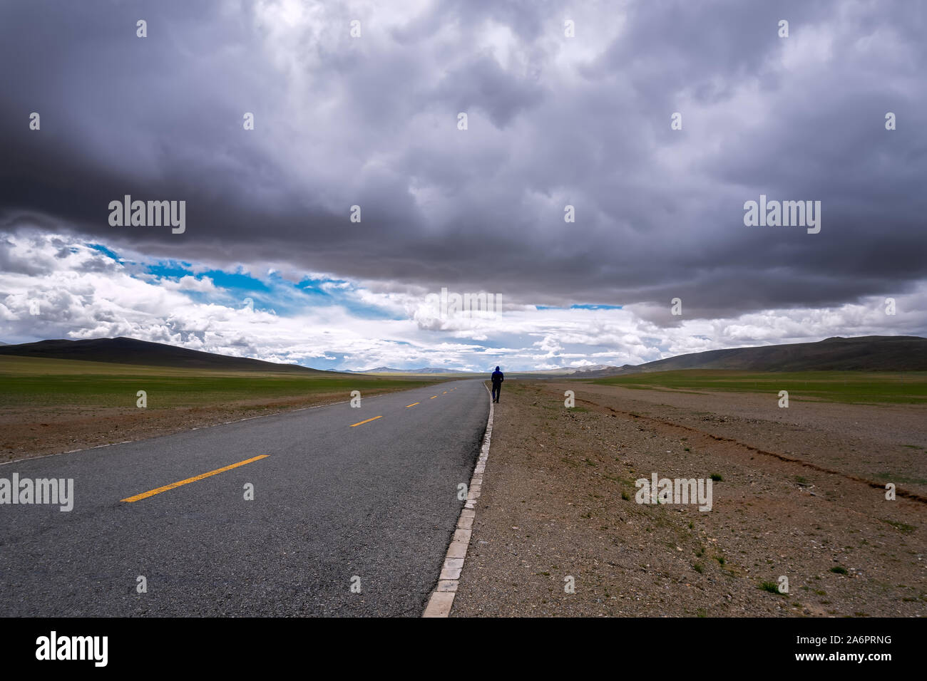 Travel forward concept background - asphalt road on plains in Himalayas with mountains and ...