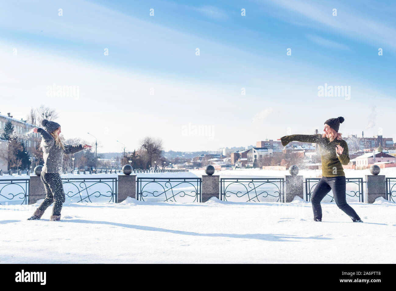 two women play snowballs Stock Photo - Alamy