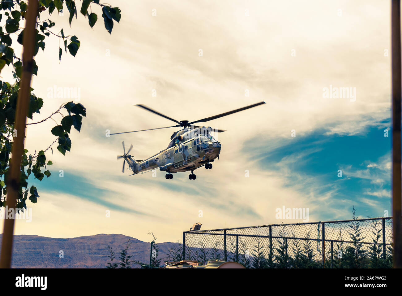 Modern tactical helicopter flying away. The chopper is filled with new ...